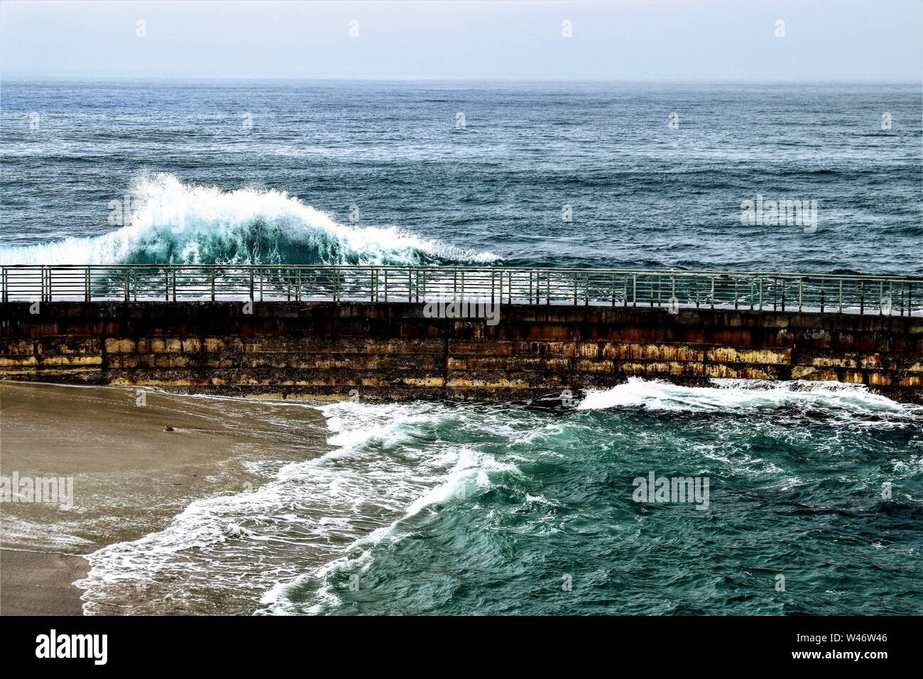 Waves crashing into beach barriers hi-res stock photography and images ...