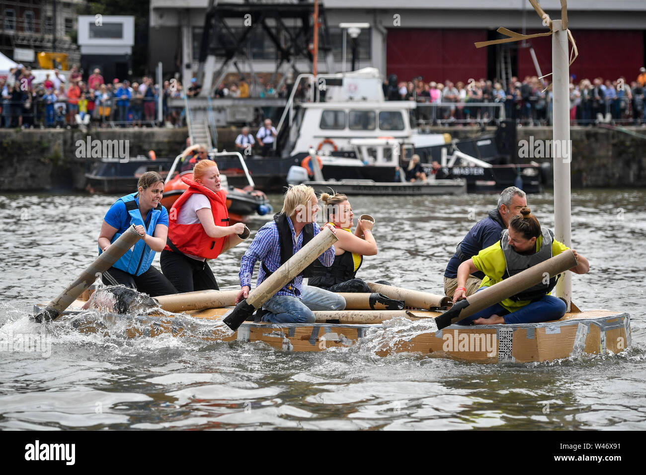 People take part in the cardboard boat race as they use cardboard tubes ...