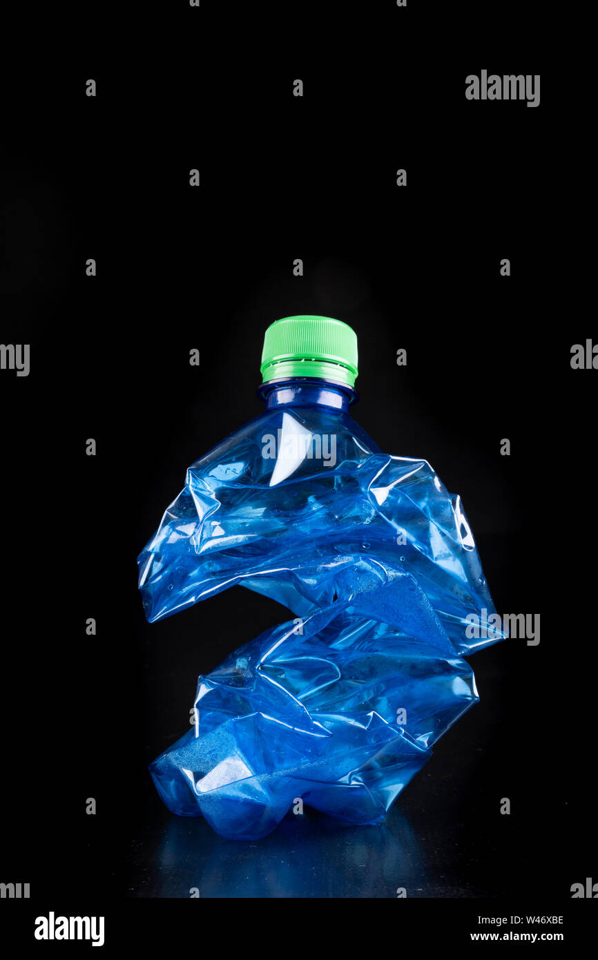 Plastic bottle on a dark table. Plastic container for drinking water ...