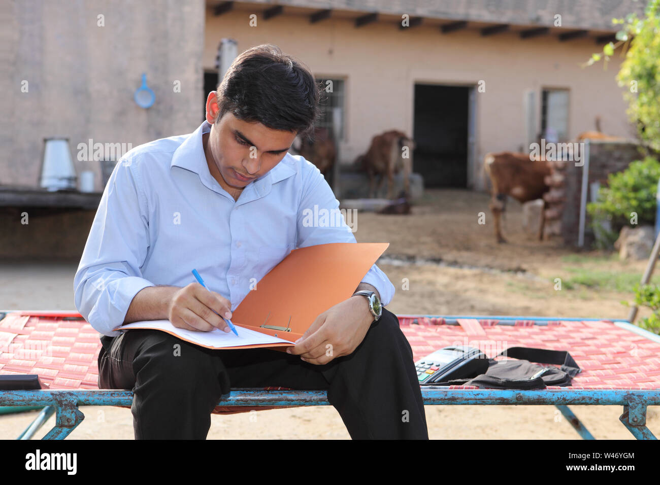 Indian executive working in a village Stock Photo - Alamy