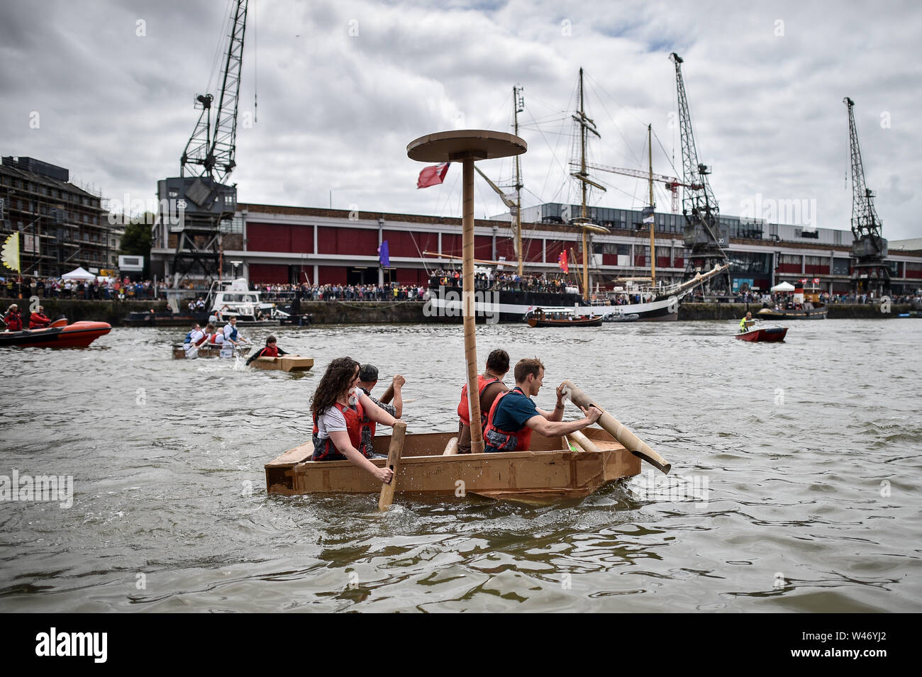 People take part in the cardboard boat race as they use cardboard tubes ...