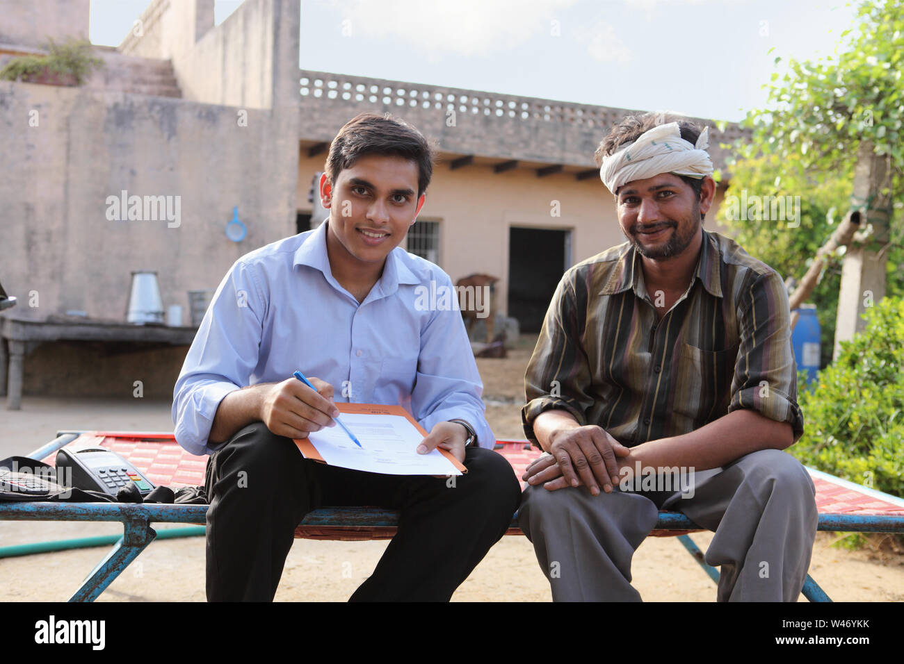 Executive explaining a villager on file Stock Photo - Alamy