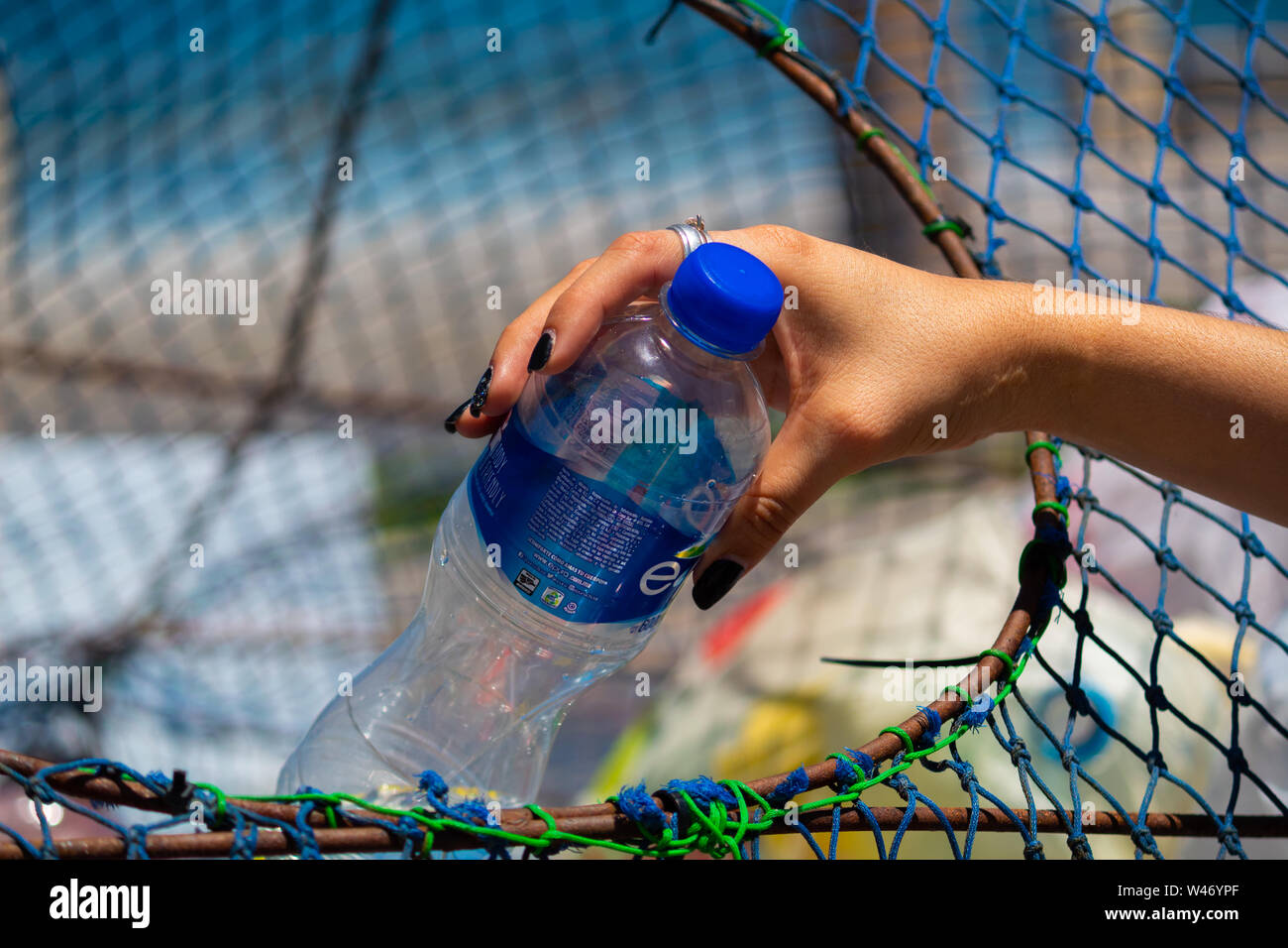 A woman's hand depositing garbage in a can to recycle plastic Stock ...