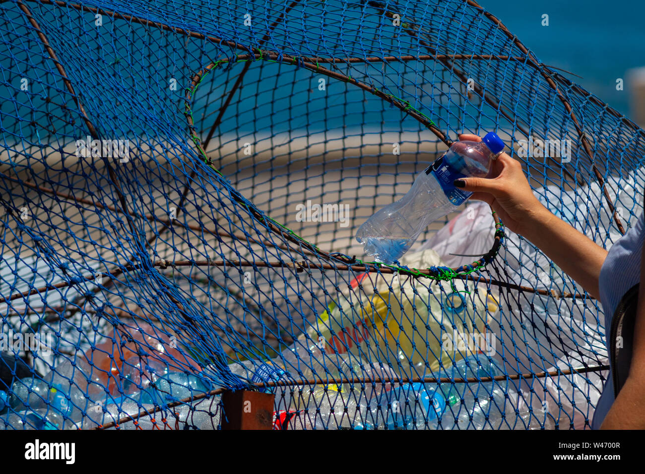 A woman's hand depositing garbage in a can to recycle plastic Stock ...
