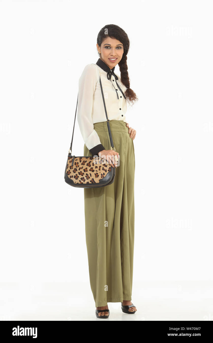 Woman standing and smiling Stock Photo - Alamy