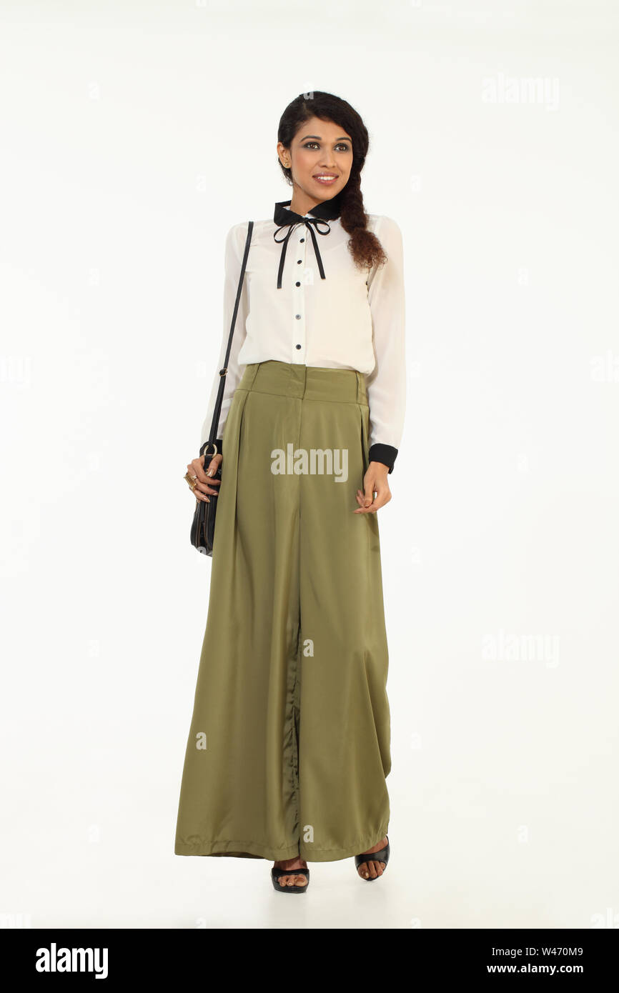 Woman standing and smiling Stock Photo - Alamy