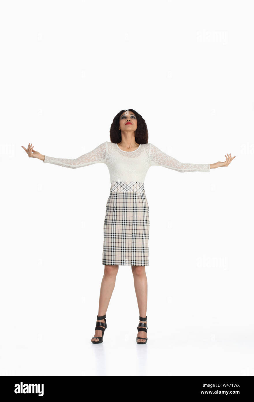 Woman standing with her arm outstretched Stock Photo - Alamy