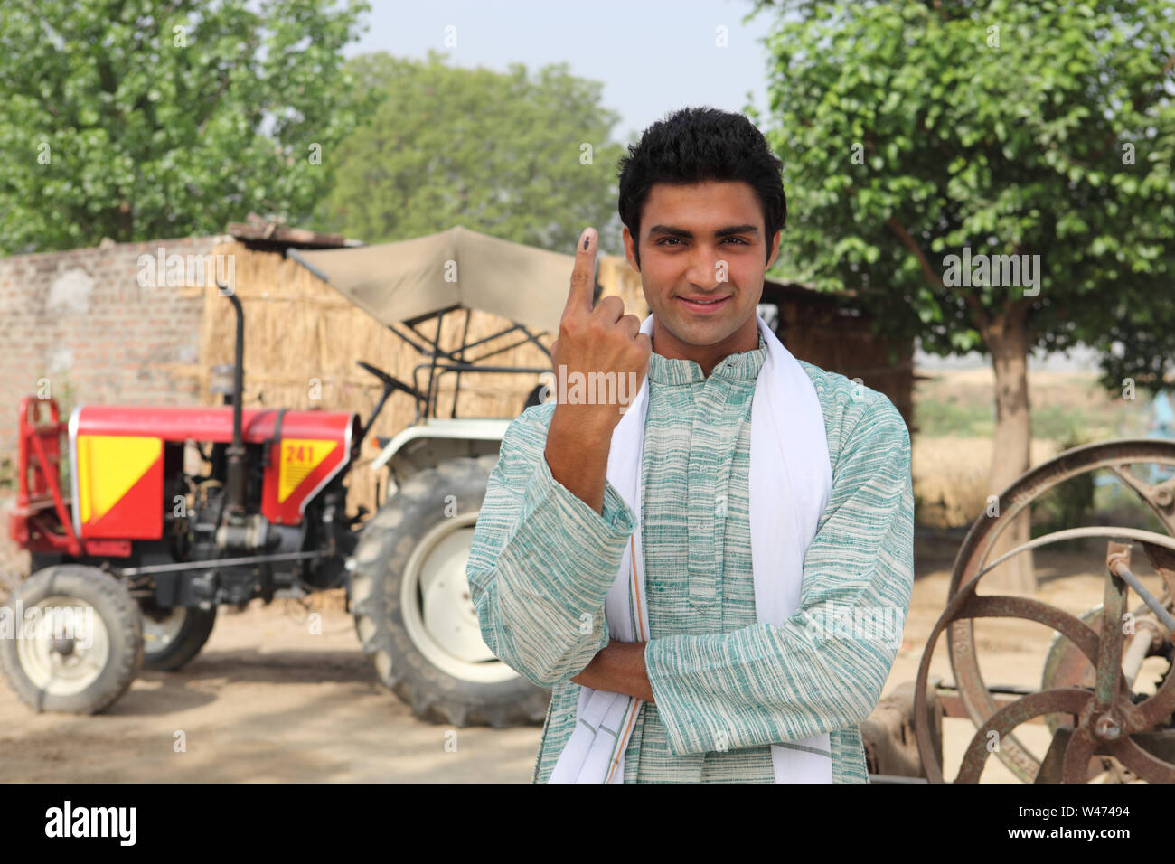 Portrait of a farmer pointing upward Stock Photo - Alamy