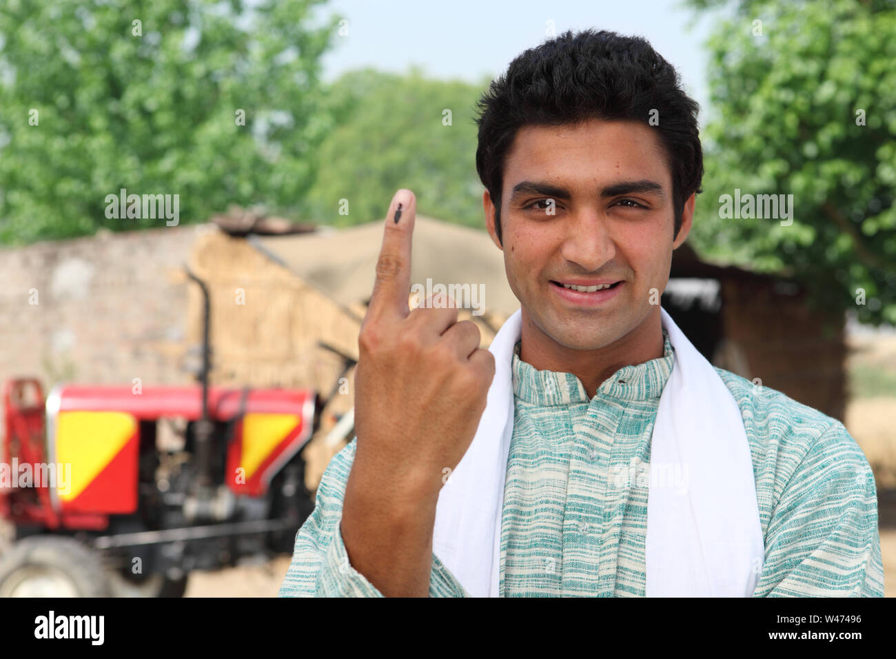 Portrait of a farmer pointing upward Stock Photo - Alamy