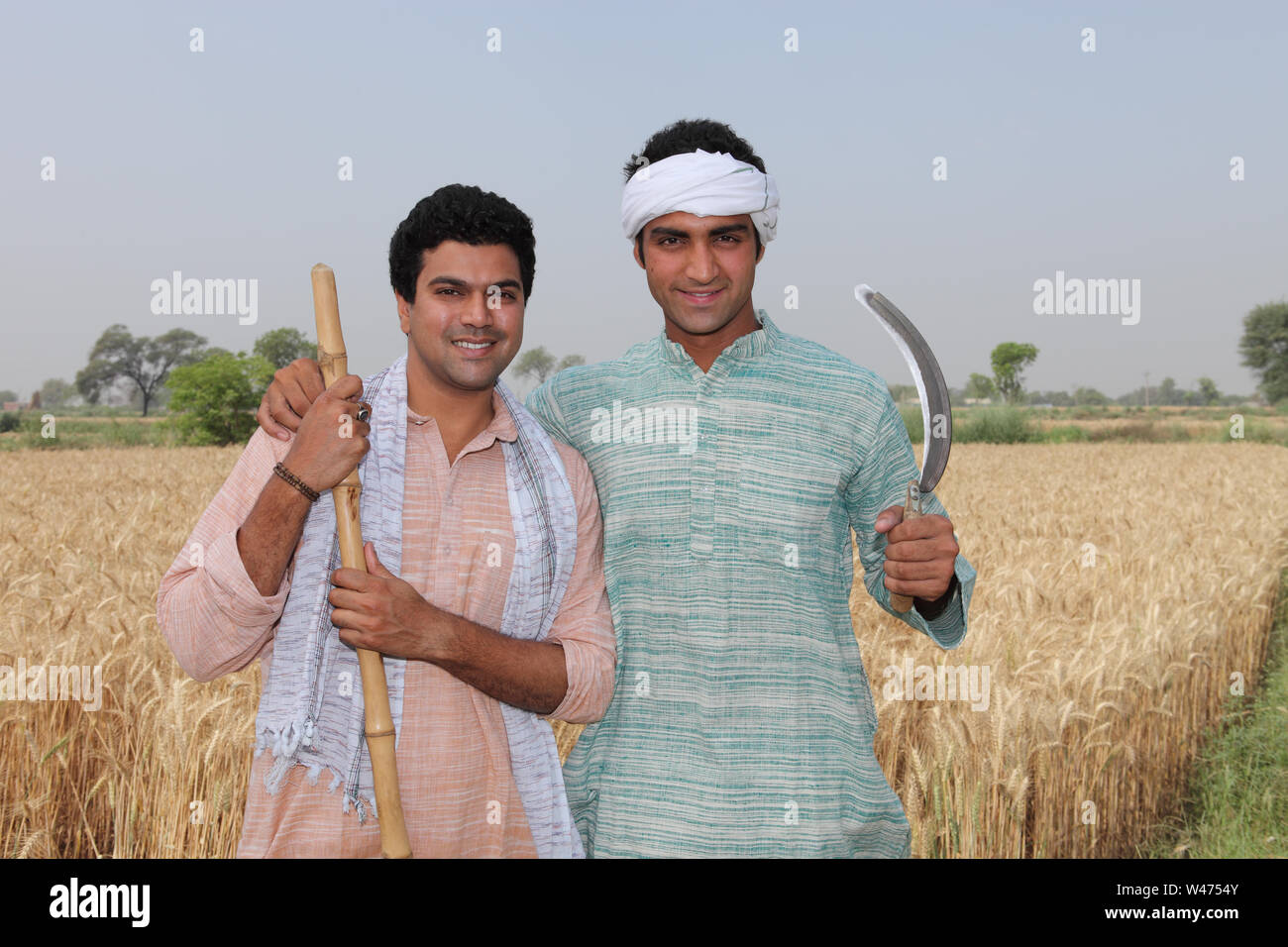 Two farmers standing in a crop field Stock Photo - Alamy