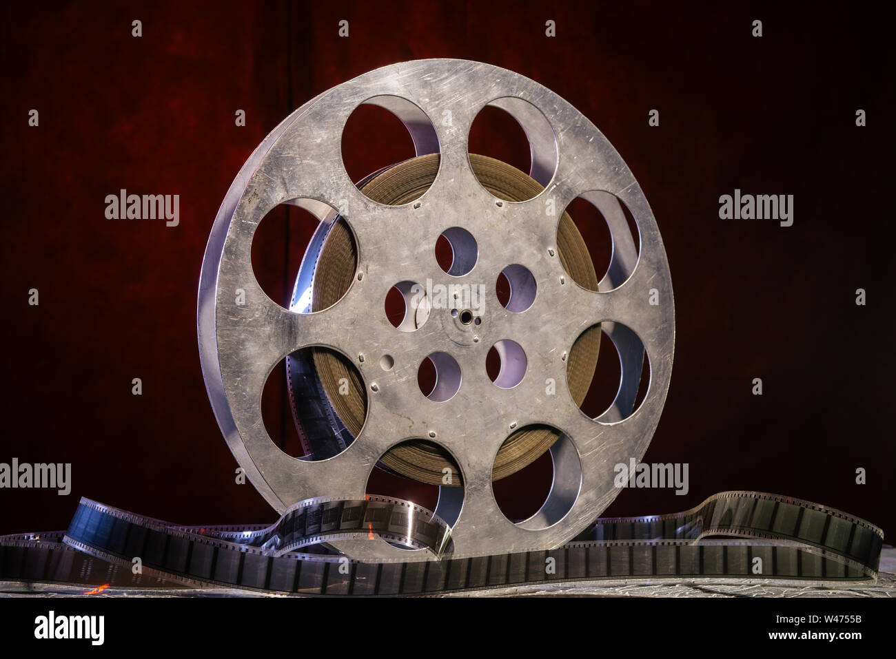 35 mm film reel with dramatic lighting on a dark background - image ...