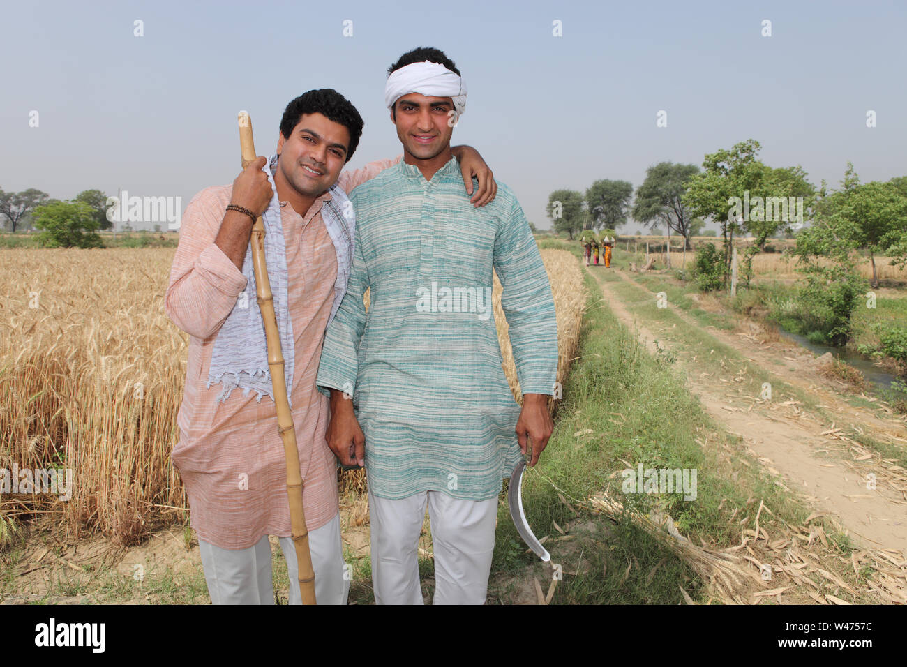 Two farmers standing in a crop field Stock Photo - Alamy