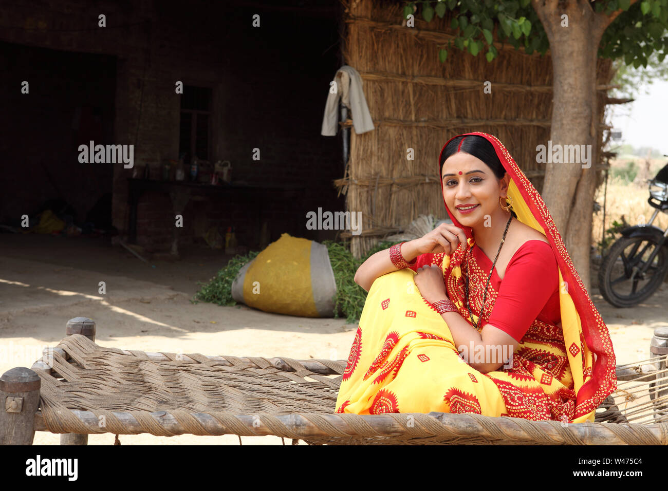 Rural woman sitting on a cot Stock Photo - Alamy