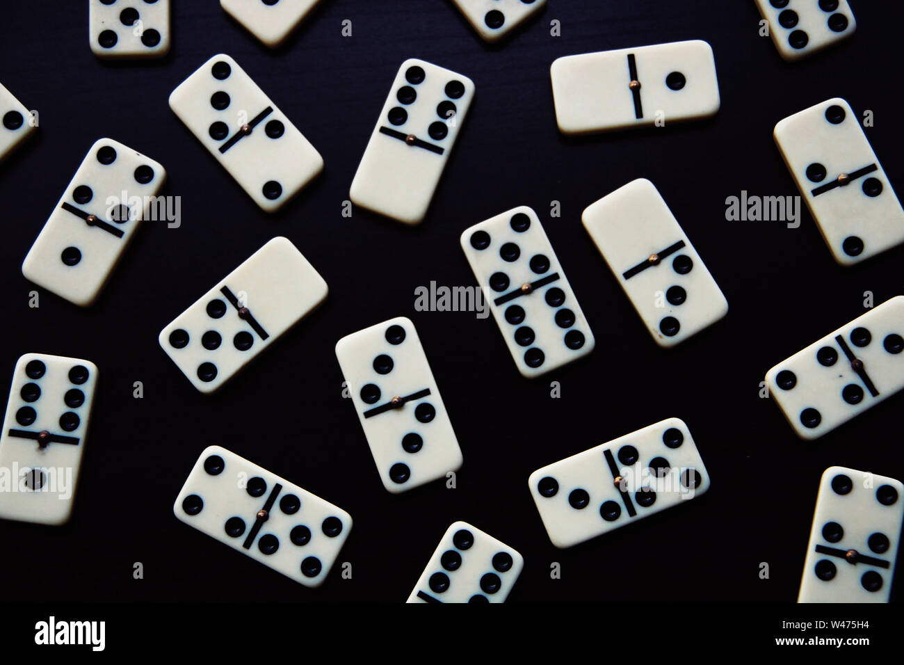 Domino tokens on a black background at home Stock Photo - Alamy