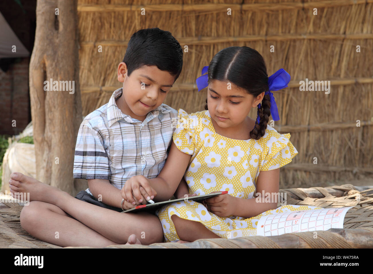 Girl teaching her brother Stock Photo - Alamy
