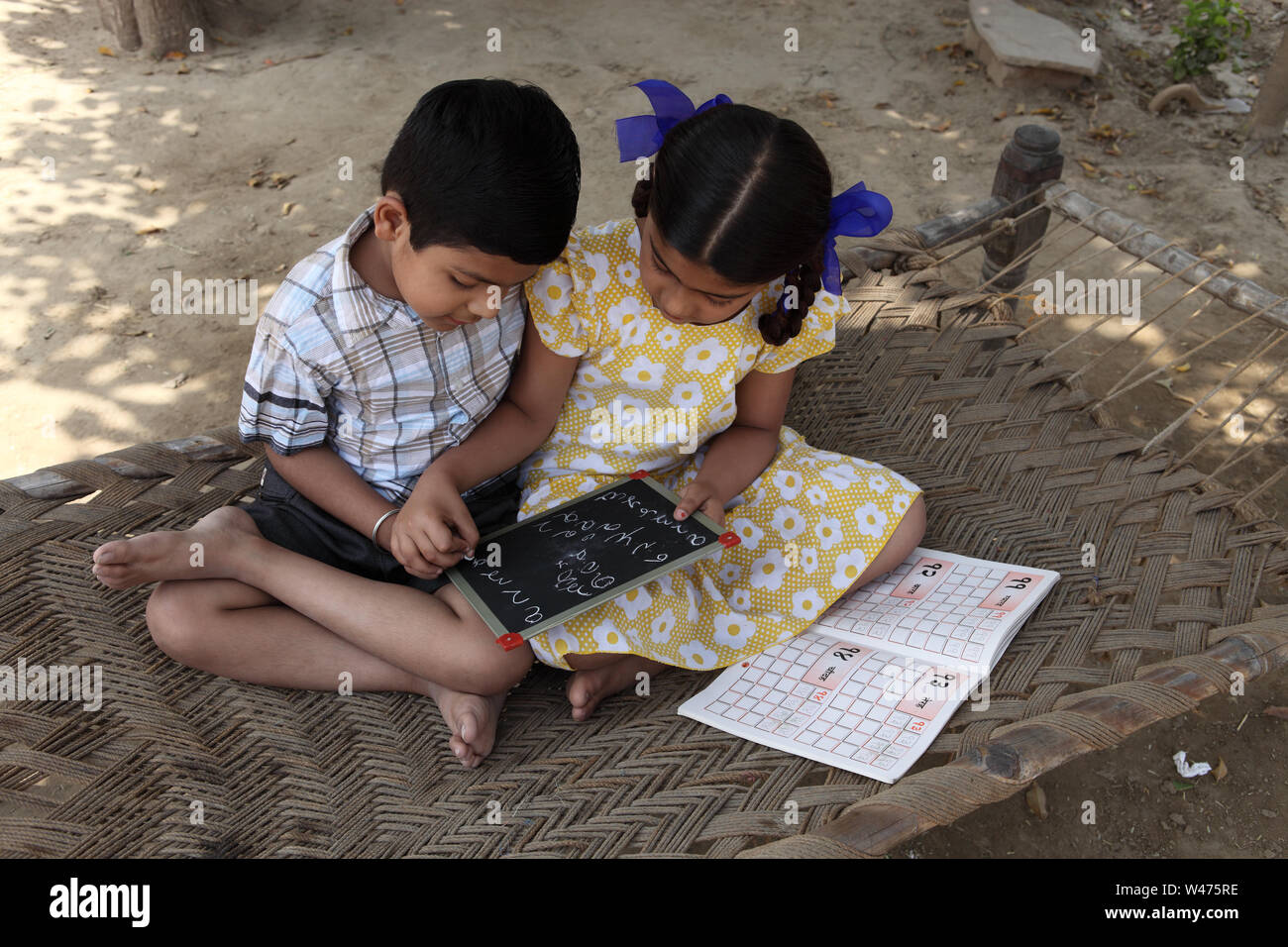 Girl teaching her brother Stock Photo - Alamy