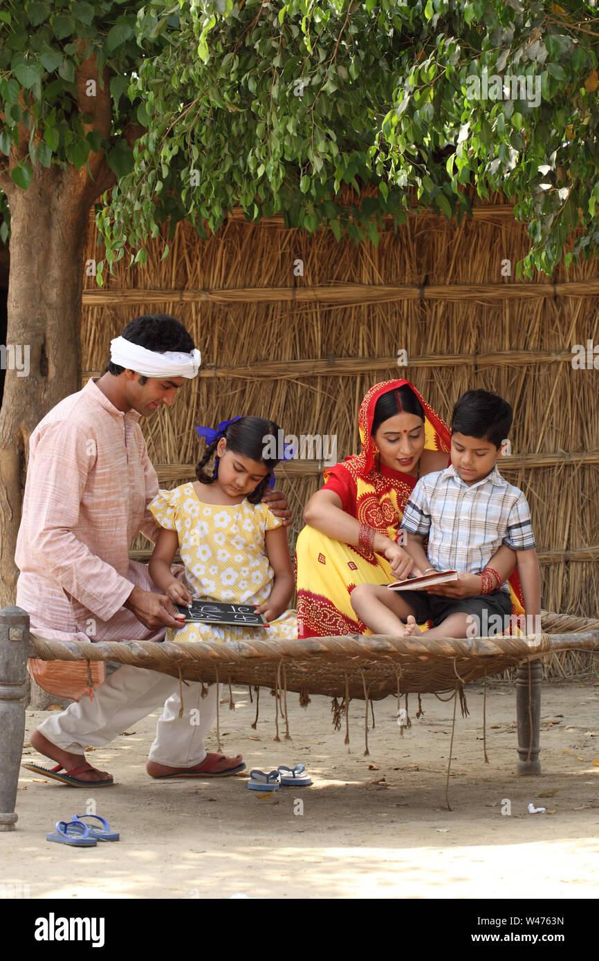 Parents teaching their children Stock Photo - Alamy Parents teaching their children Stock Photo - Alamy