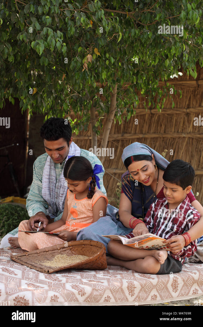 Parents teaching their children Stock Photo - Alamy Parents teaching their children Stock Photo - Alamy