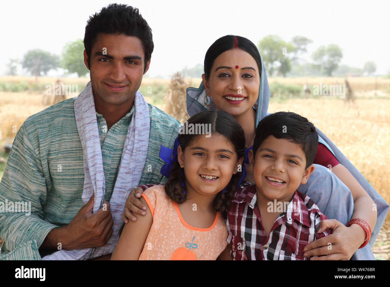 Portrait of Indian rural family smiling Stock Photo - Alamy