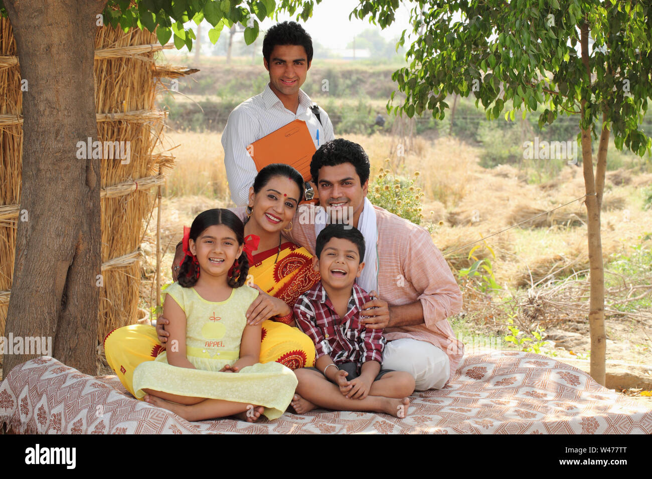 Rural family sitting together and smiling Stock Photo - Alamy