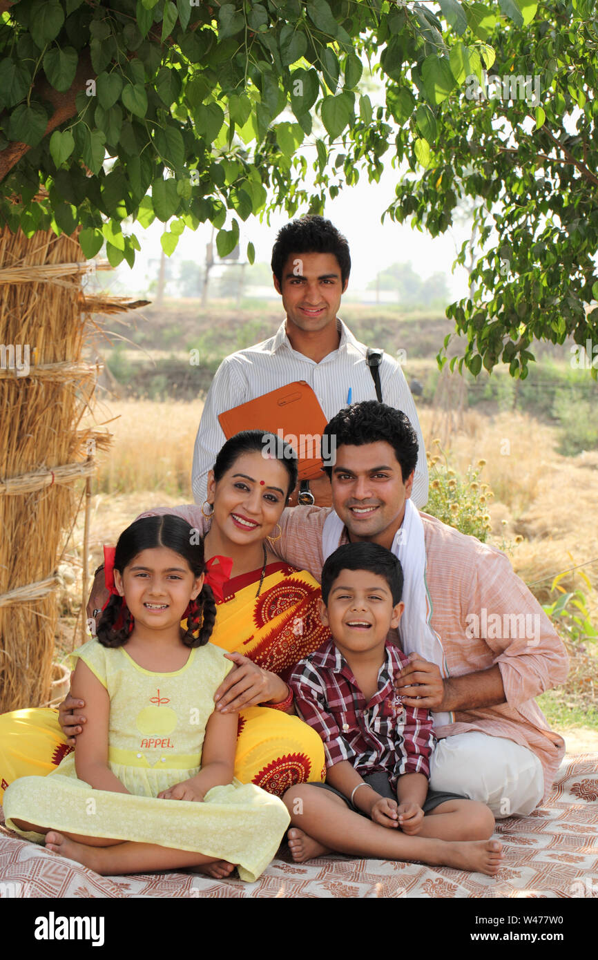 Rural family sitting together and smiling Stock Photo - Alamy