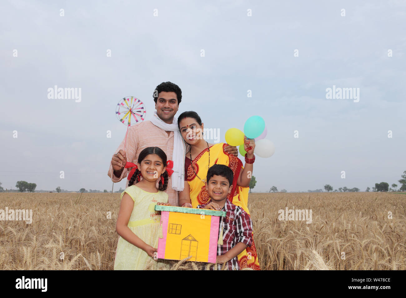Family showing dream home and smiling Stock Photo - Alamy