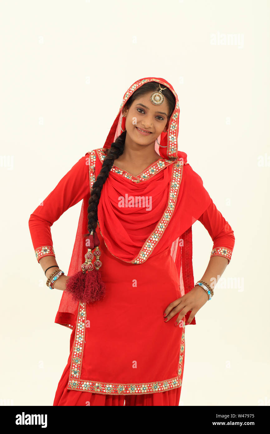 Woman standing with arms akimbo Stock Photo - Alamy