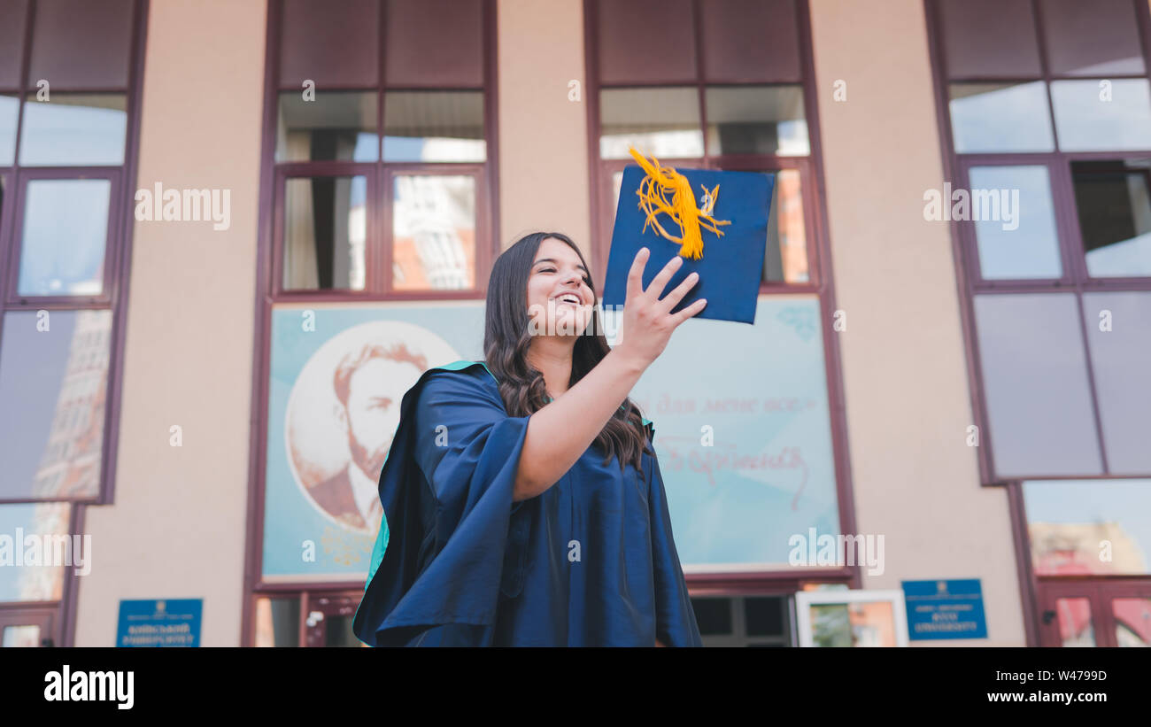 University graduates throwing graduation hats in the air. Group of ...