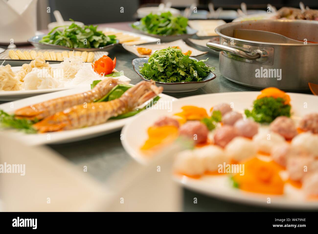 big round table with different side dishes on it Stock Photo - Alamy