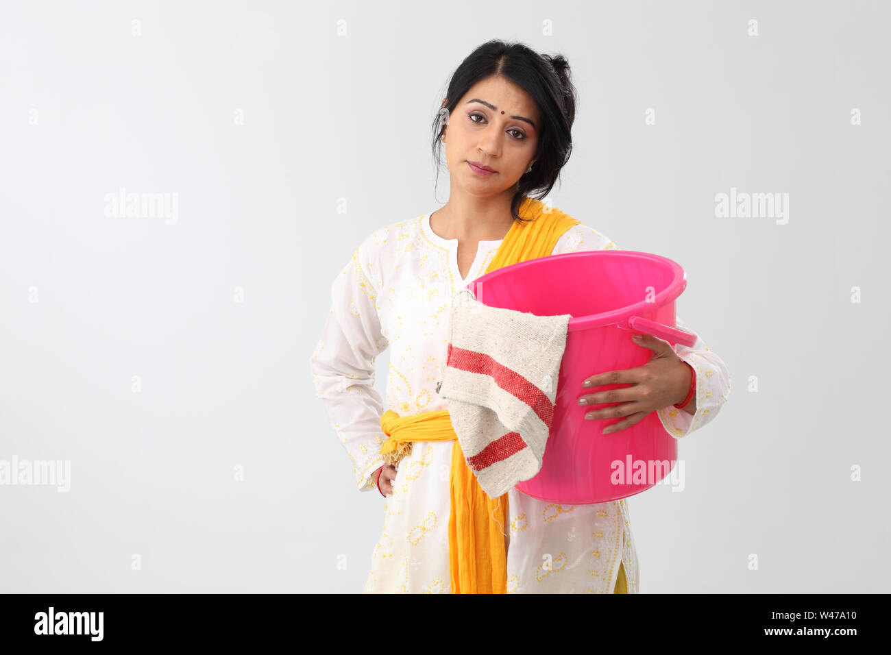 Portrait of a woman holding a bucket Stock Photo - Alamy