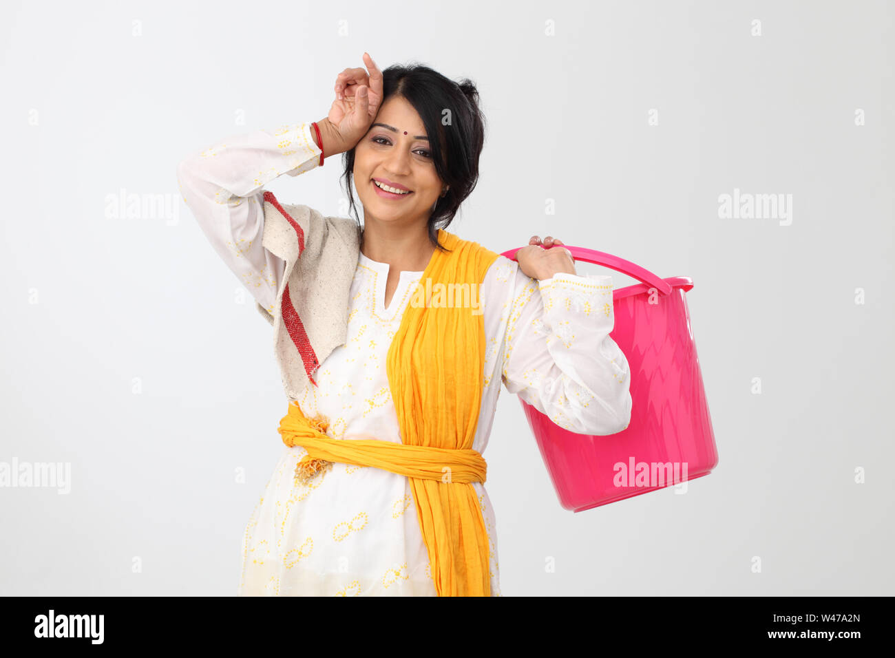 woman holding a bucket and smiling Stock Photo - Alamy