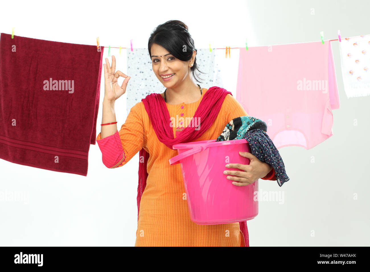 Indian woman washing clothes by hand hi-res stock photography and ...