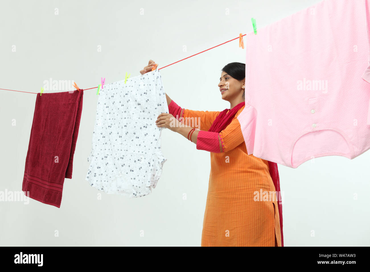 Indian woman drying clothes hi-res stock photography and images - Alamy