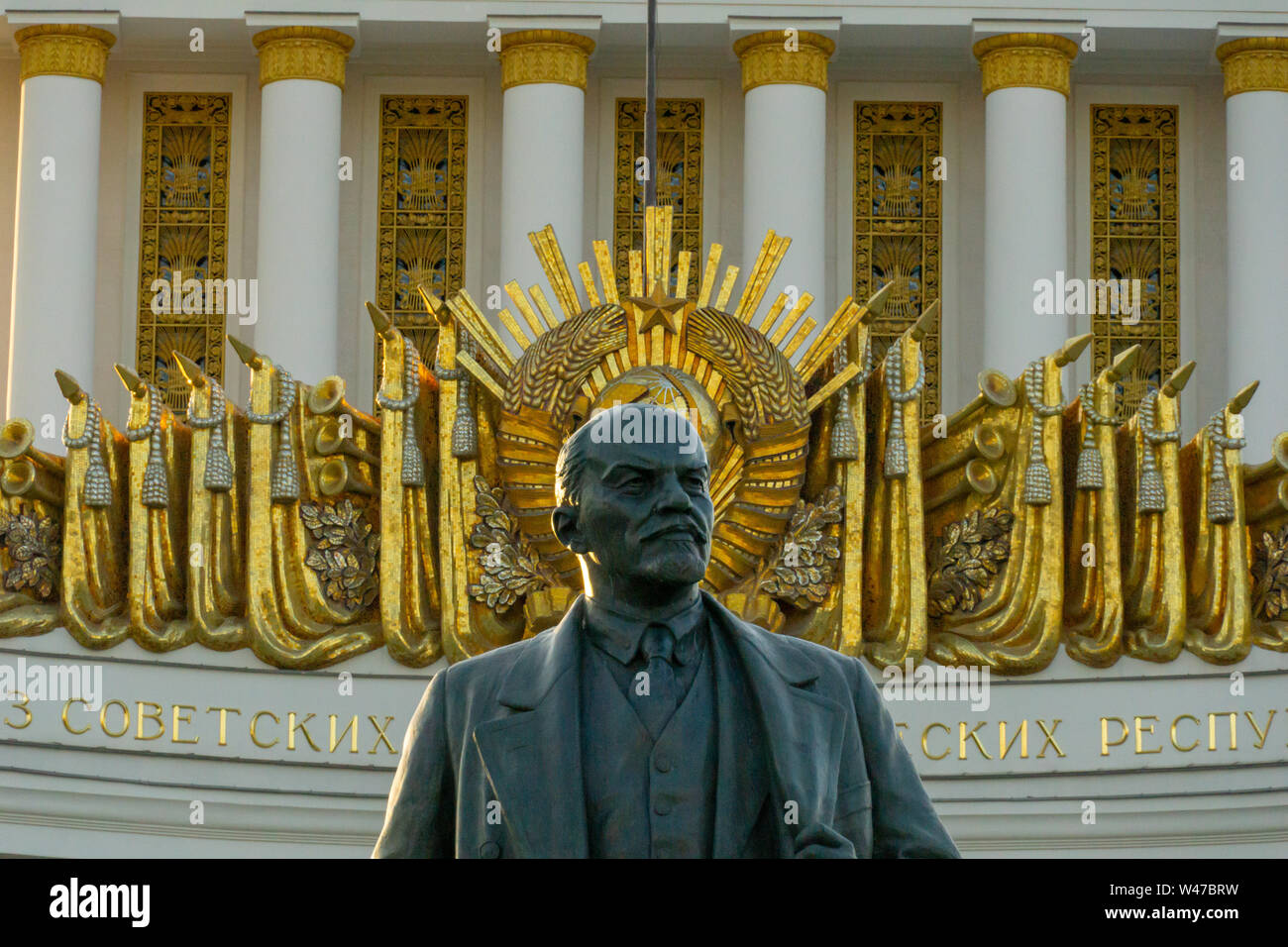 Soviet communist leader Vladimir Lenin statue in front of old building ...