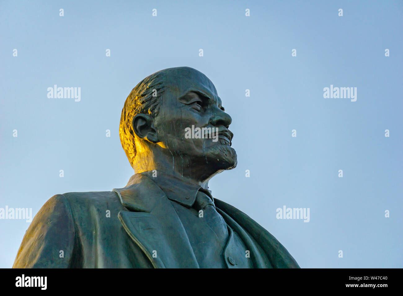 Soviet communist leader Vladimir Lenin statue in front of old building ...