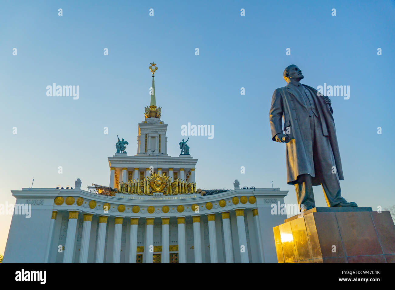 Soviet communist leader Vladimir Lenin statue in front of old building ...