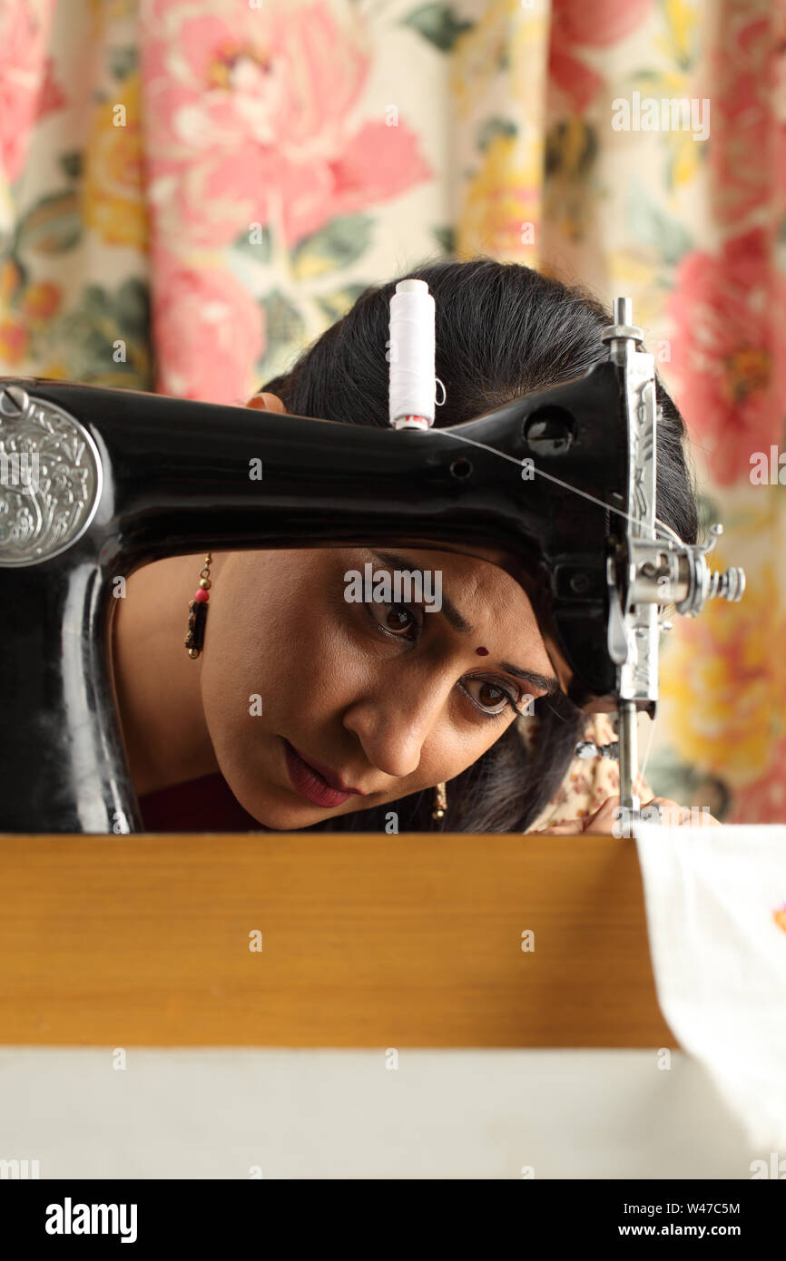 Indian woman using sewing machine hi-res stock photography and images ...