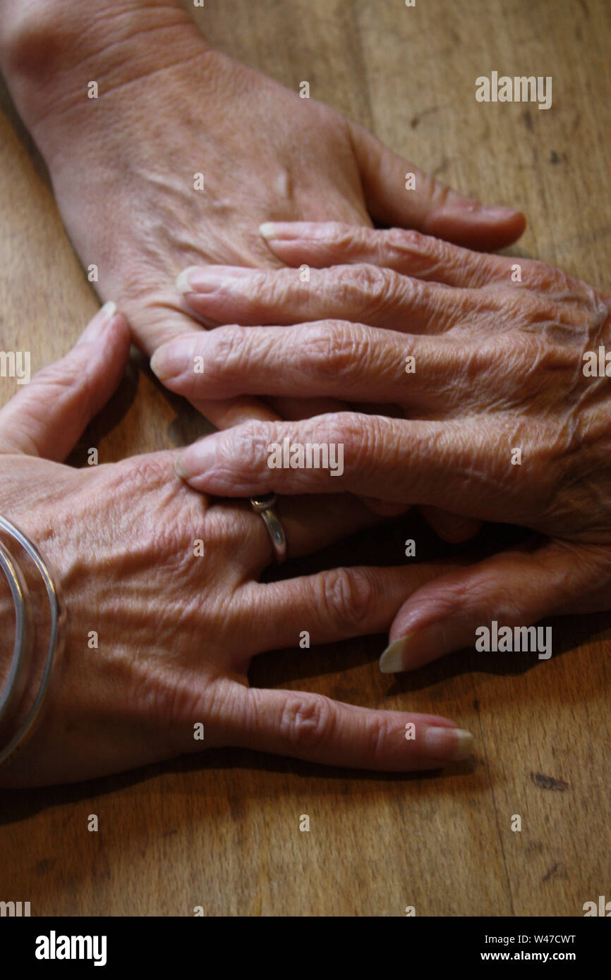 Hands overlapping each other Stock Photo - Alamy