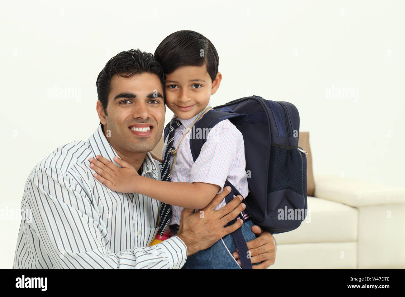 Man hugging his son and smiling Stock Photo - Alamy