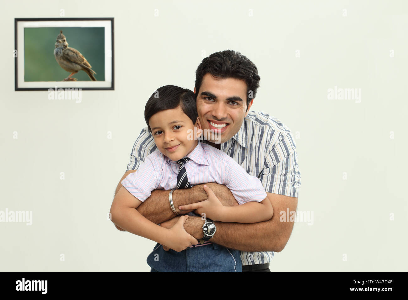 Man hugging his son and smiling Stock Photo - Alamy