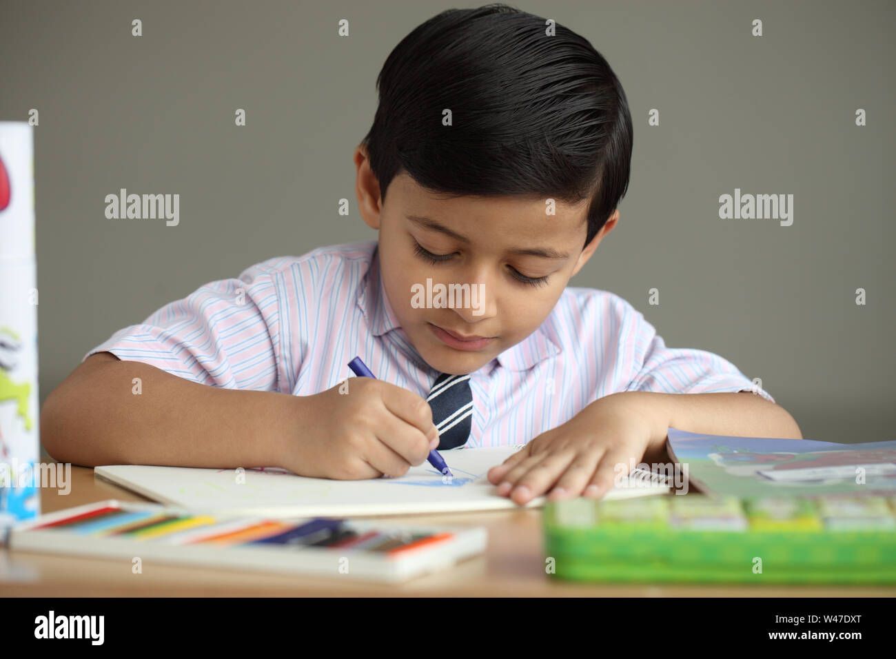 Boy coloring on a book Stock Photo - Alamy