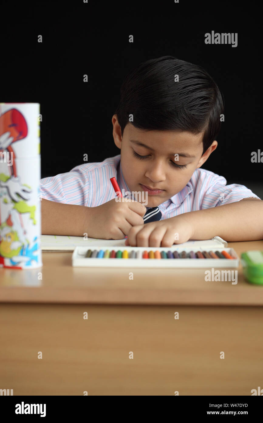 Boy coloring on a book Stock Photo - Alamy