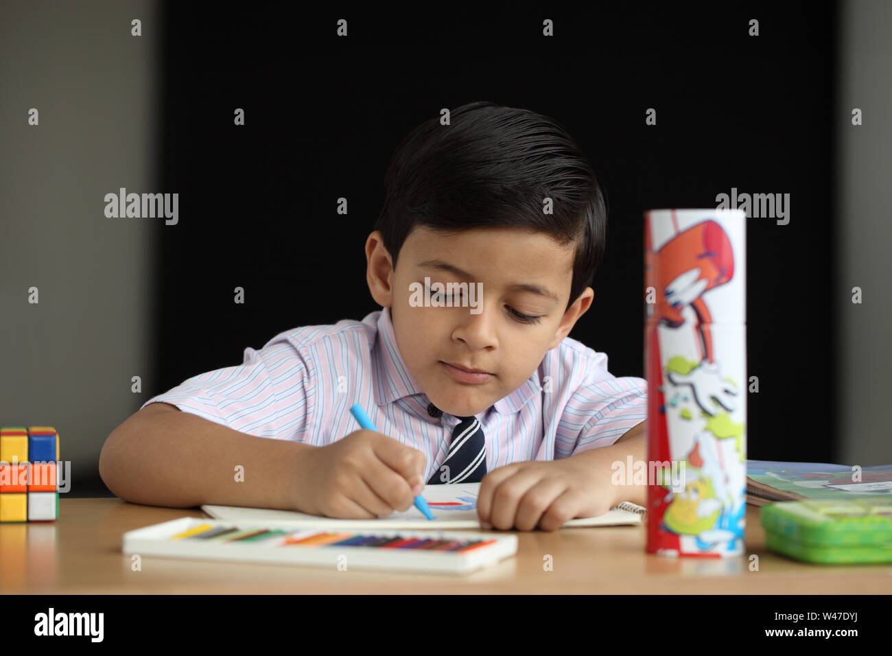 Boy coloring on a book Stock Photo - Alamy
