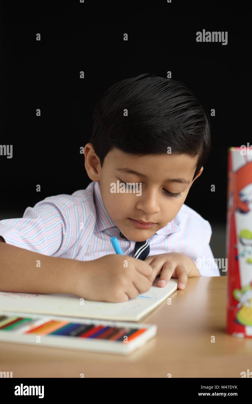 Boy coloring on a book Stock Photo - Alamy