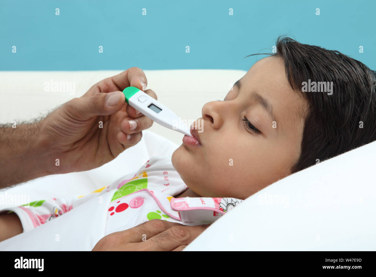Indian man checking his son temperature Stock Photo - Alamy