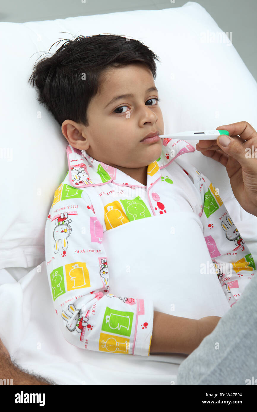 Man checking his son temperature Stock Photo - Alamy