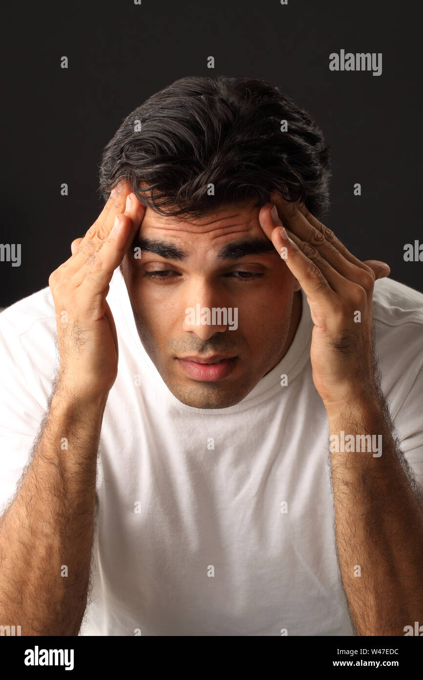 Indian male touching forehead hi-res stock photography and images - Alamy