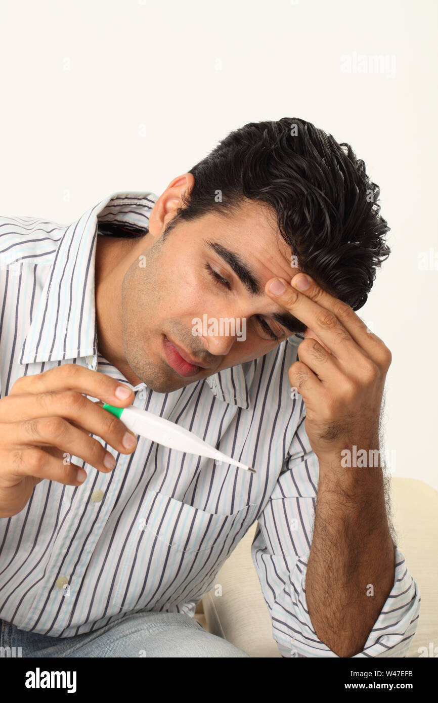 Man checking his temperature Stock Photo - Alamy