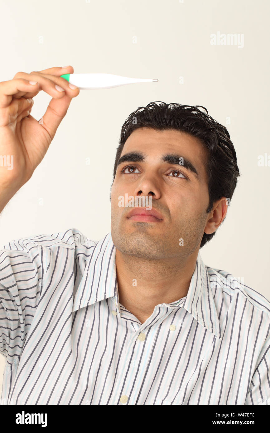 Man checking his temperature Stock Photo - Alamy