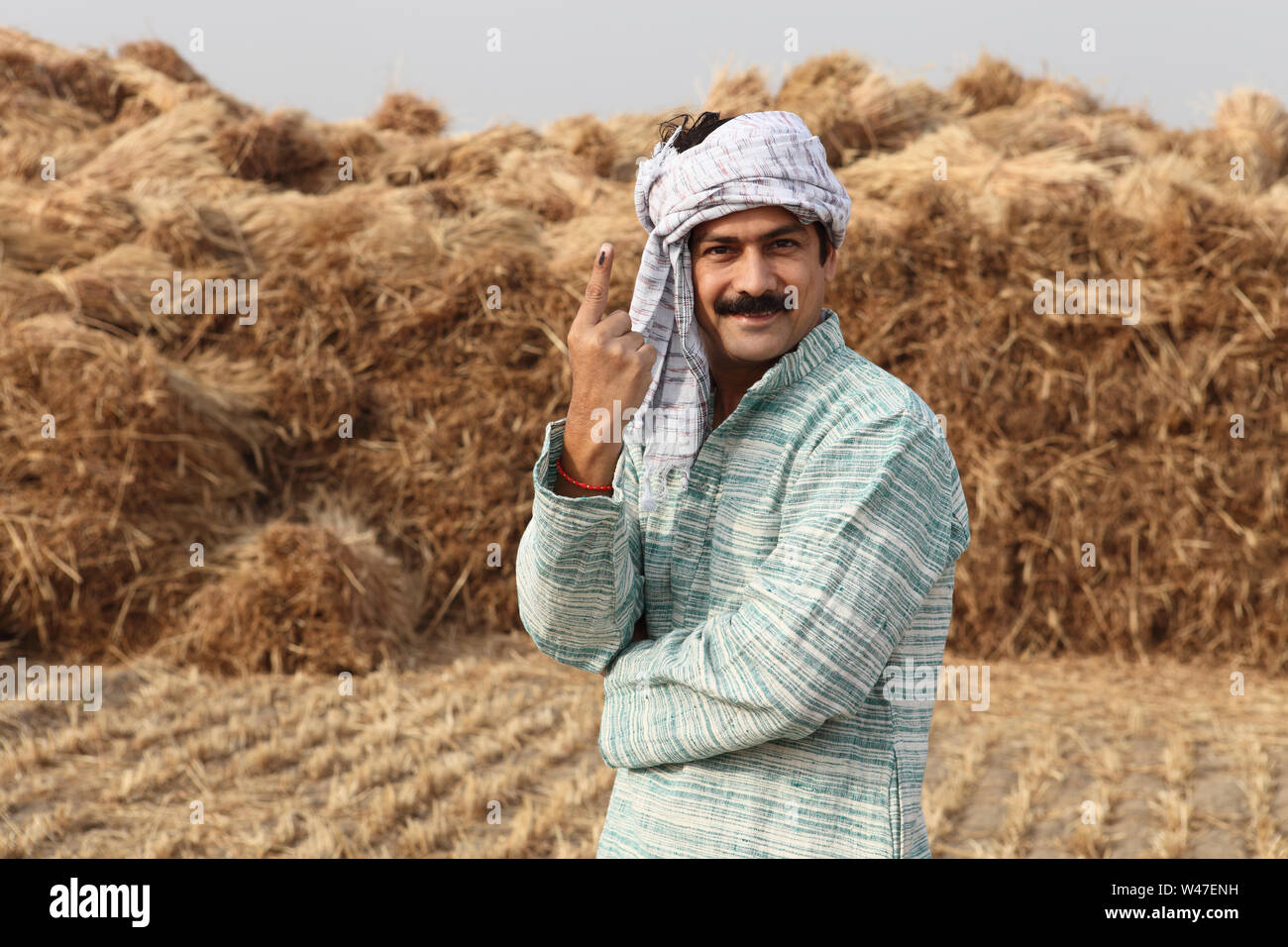 Farmer pointing upward standing in a field Stock Photo - Alamy